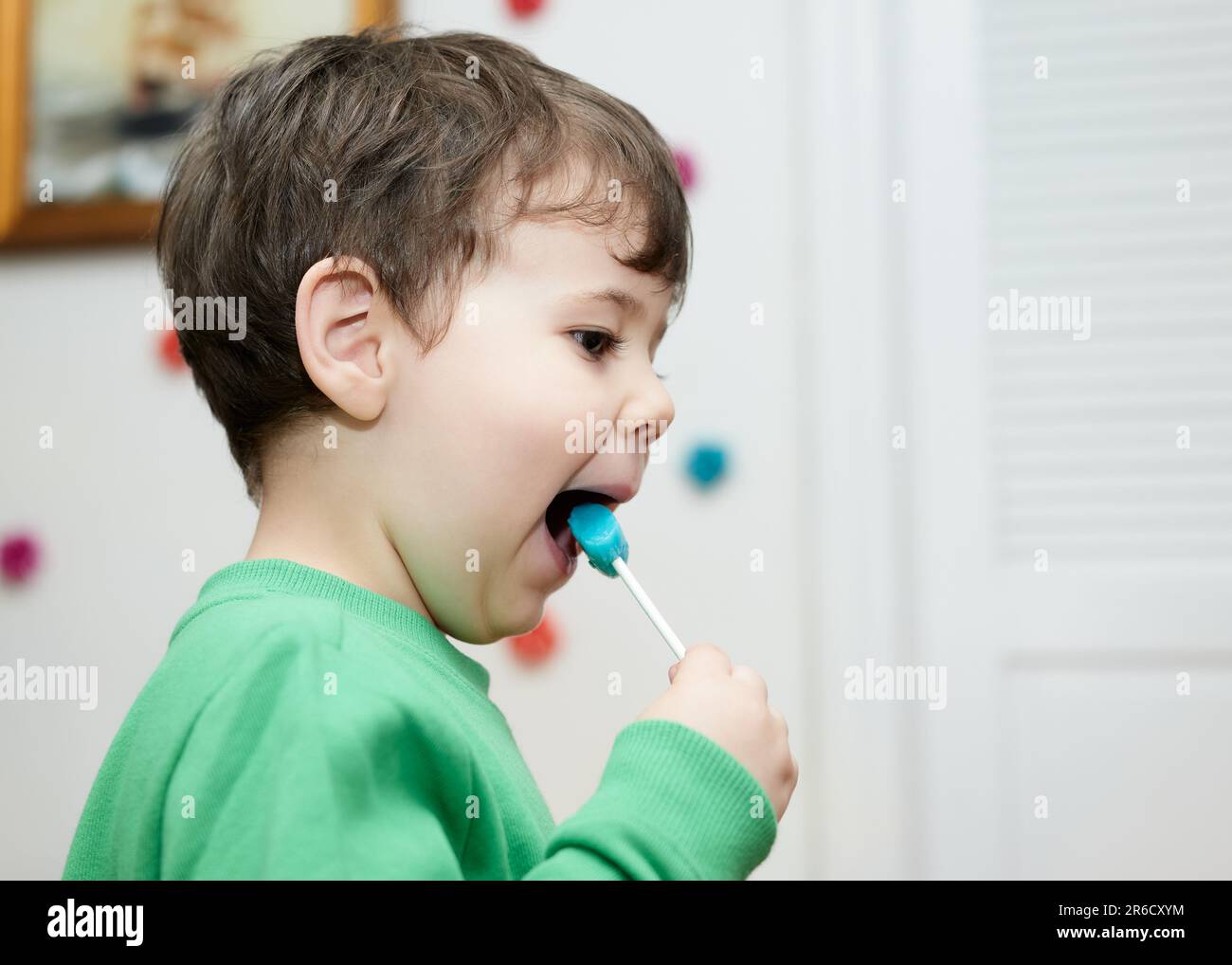 Cute baby boy enjoying a lollipop at home Stock Photo - Alamy