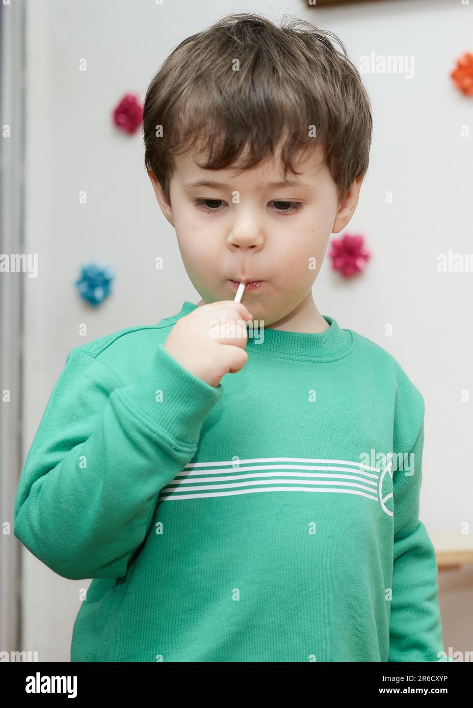 Cute baby boy enjoying a lollipop at home Stock Photo - Alamy