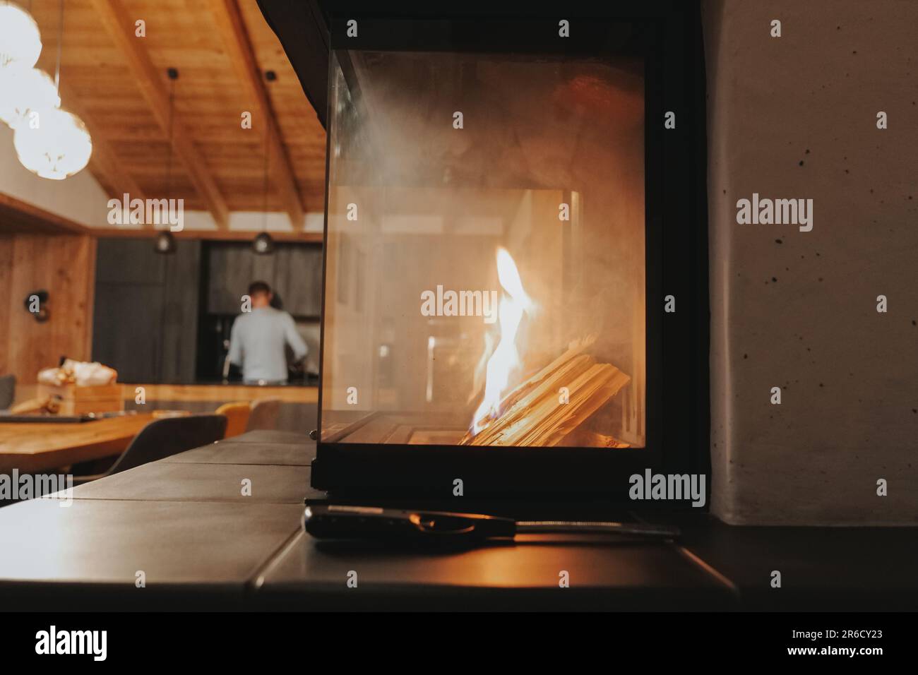 Fire up the fireplace. Warm cozy home atmosphere.Glass fireplace in the ...