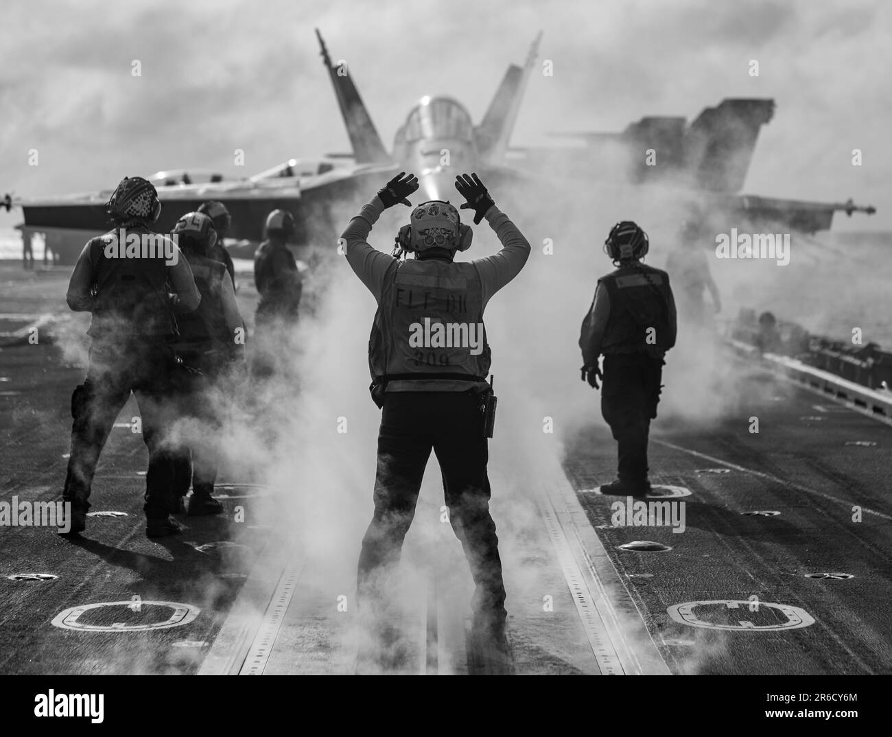 230608-N-DU622-1080 PACIFIC OCEAN (June 8, 2023) A U.S. Navy Sailor directs an F/A-18E Super ...