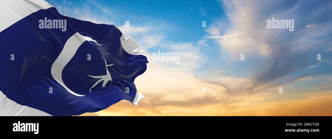 official flag of Bendera Permaisuri Johor Malaysia at cloudy sky background on sunset, panoramic ...
