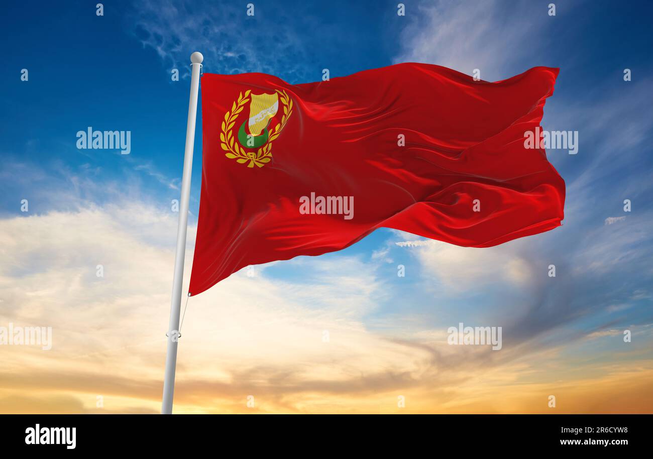 official flag of Kedah Malaysia at cloudy sky background on sunset ...