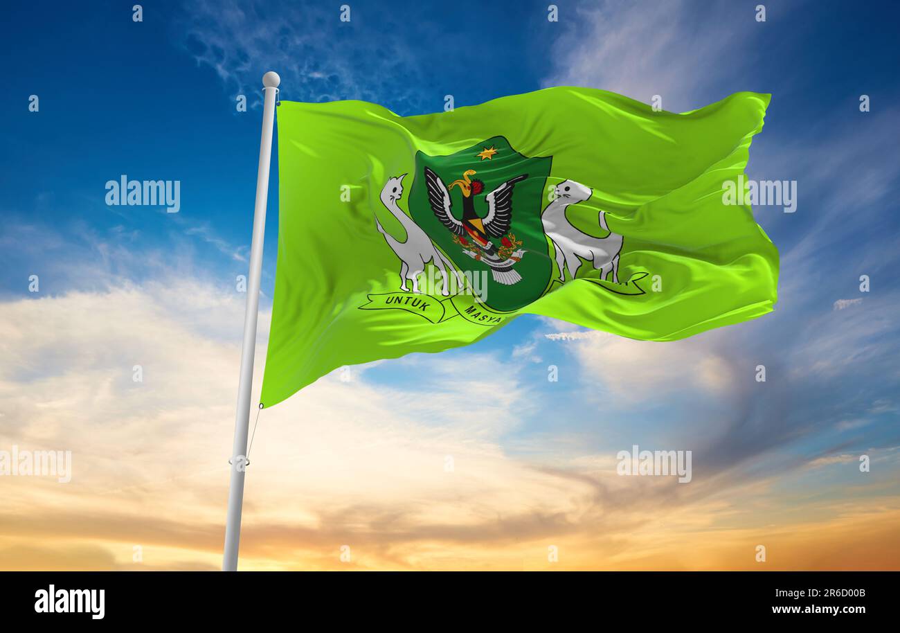 official flag of Kuching Malaysia at cloudy sky background on sunset ...