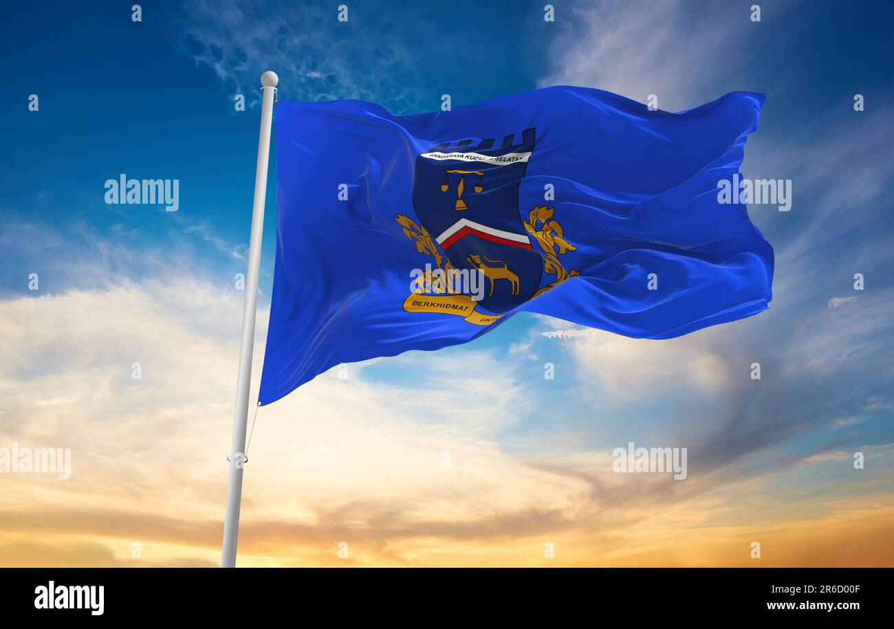 official flag of Kuching Malaysia at cloudy sky background on sunset ...