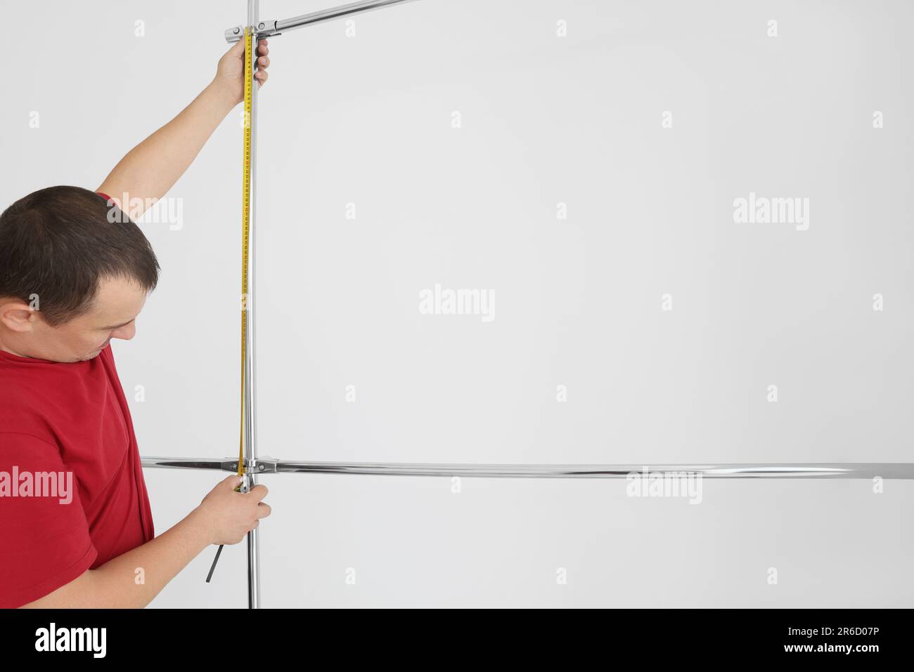 Worker measuring metal pipes for installation, closeup Stock Photo - Alamy