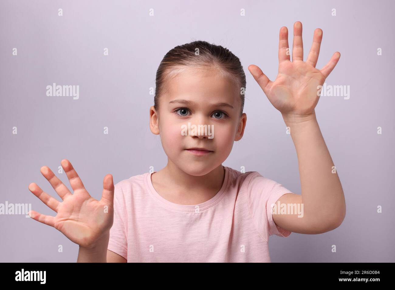 Cute little girl stuck to transparent screen Stock Photo - Alamy