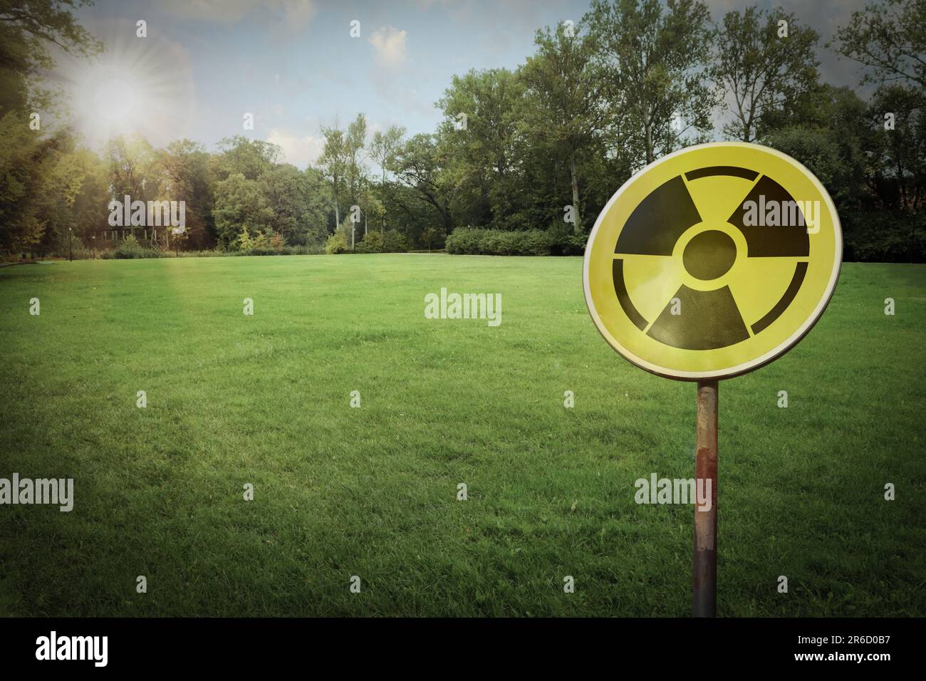 Radioactive pollution. Yellow warning sign with hazard symbol near ...