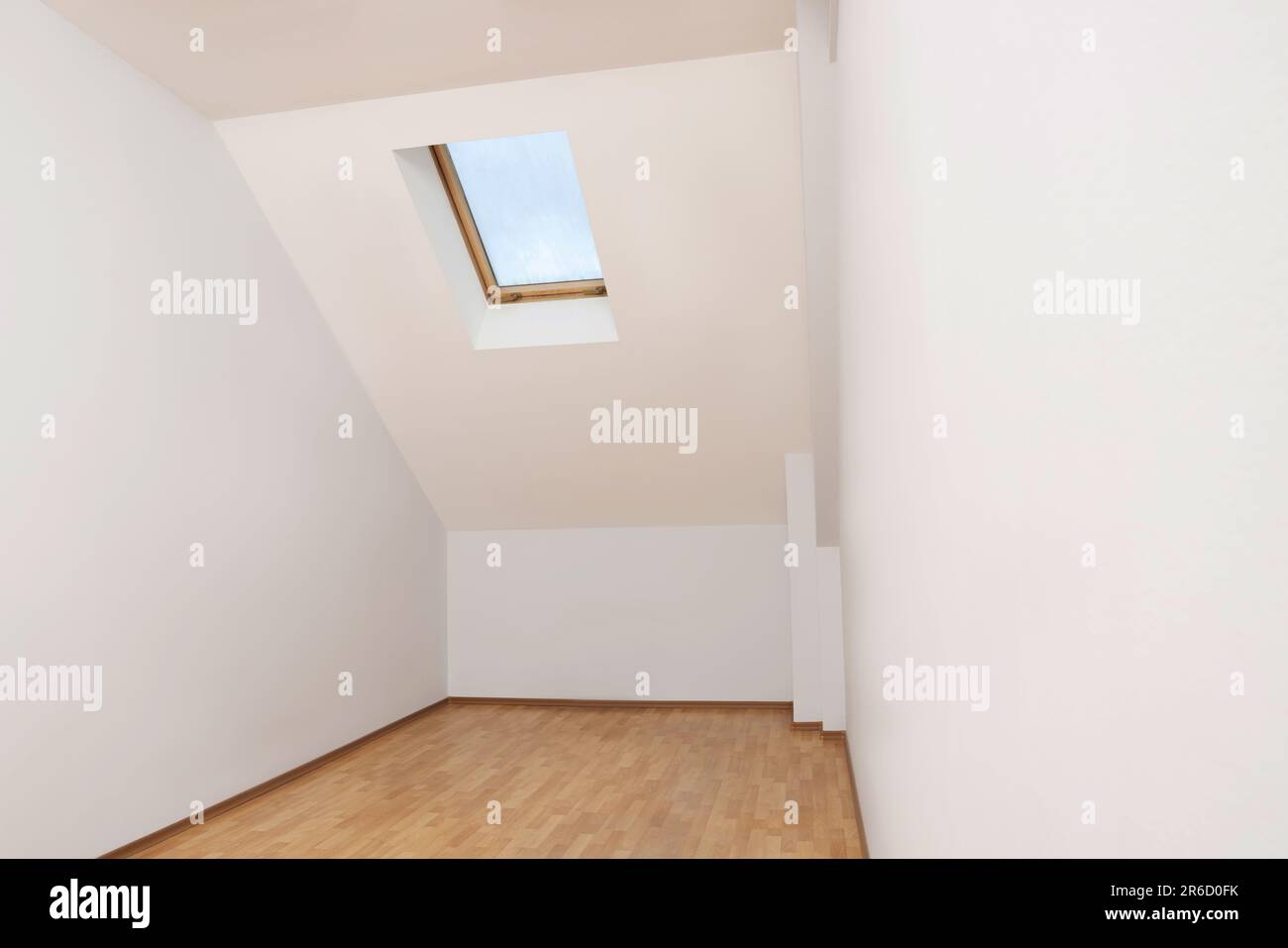 Light spacious attic room with window on slanted ceiling Stock Photo ...