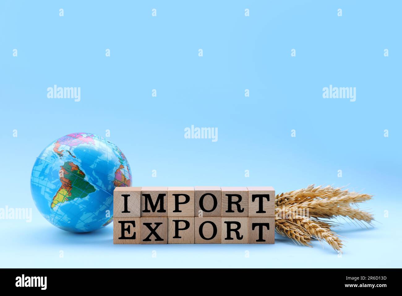 Words Import and Export made of wooden cubes, globe and ears of wheat ...