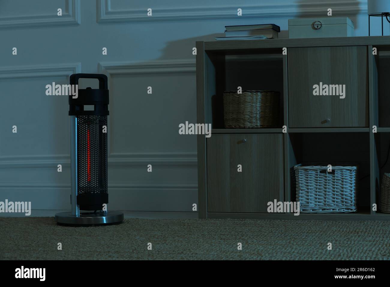 Electric infrared heater in dark room at night Stock Photo - Alamy