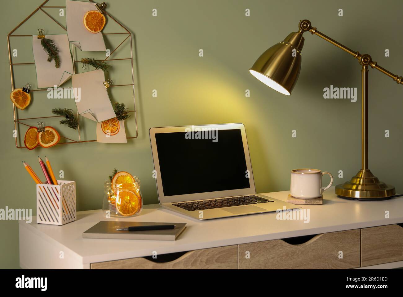 Stylish workplace with handmade decor made of dry orange slices and ...