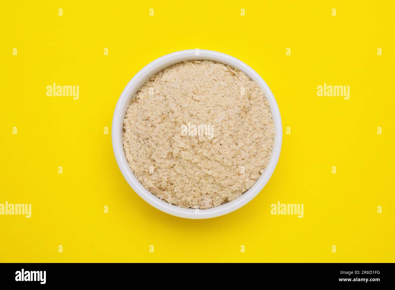 Beer yeast flakes on yellow background, top view Stock Photo - Alamy
