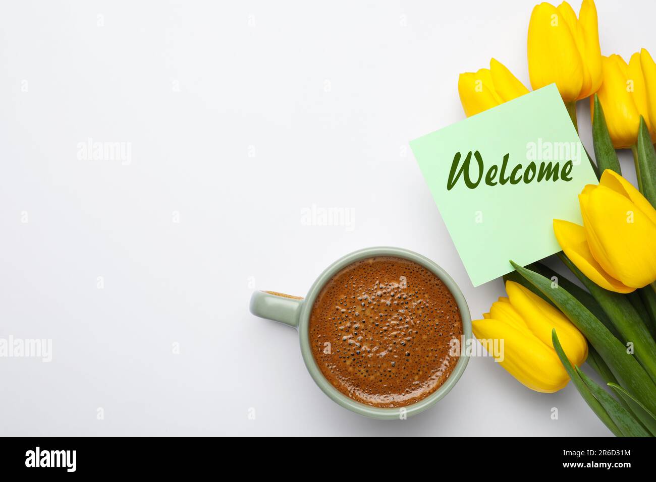 Welcome card, beautiful yellow tulips and cup of aromatic coffee on ...