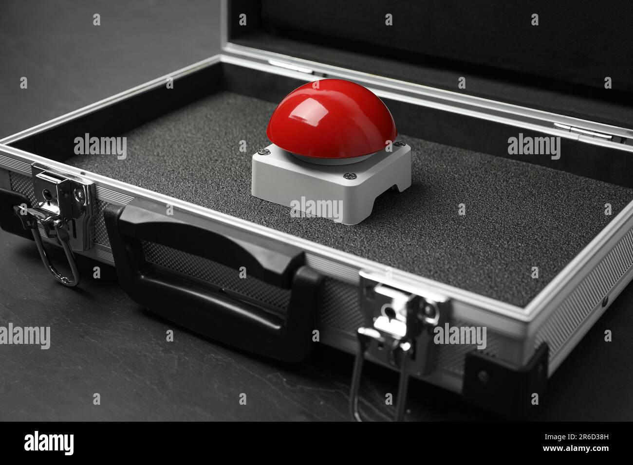 Red button of nuclear weapon in suitcase on black background. War ...