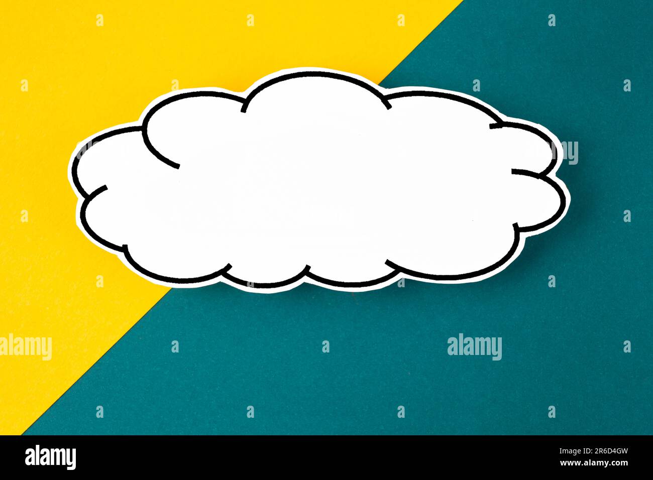 White speech bubble shaped post it note on yellow and green background ...