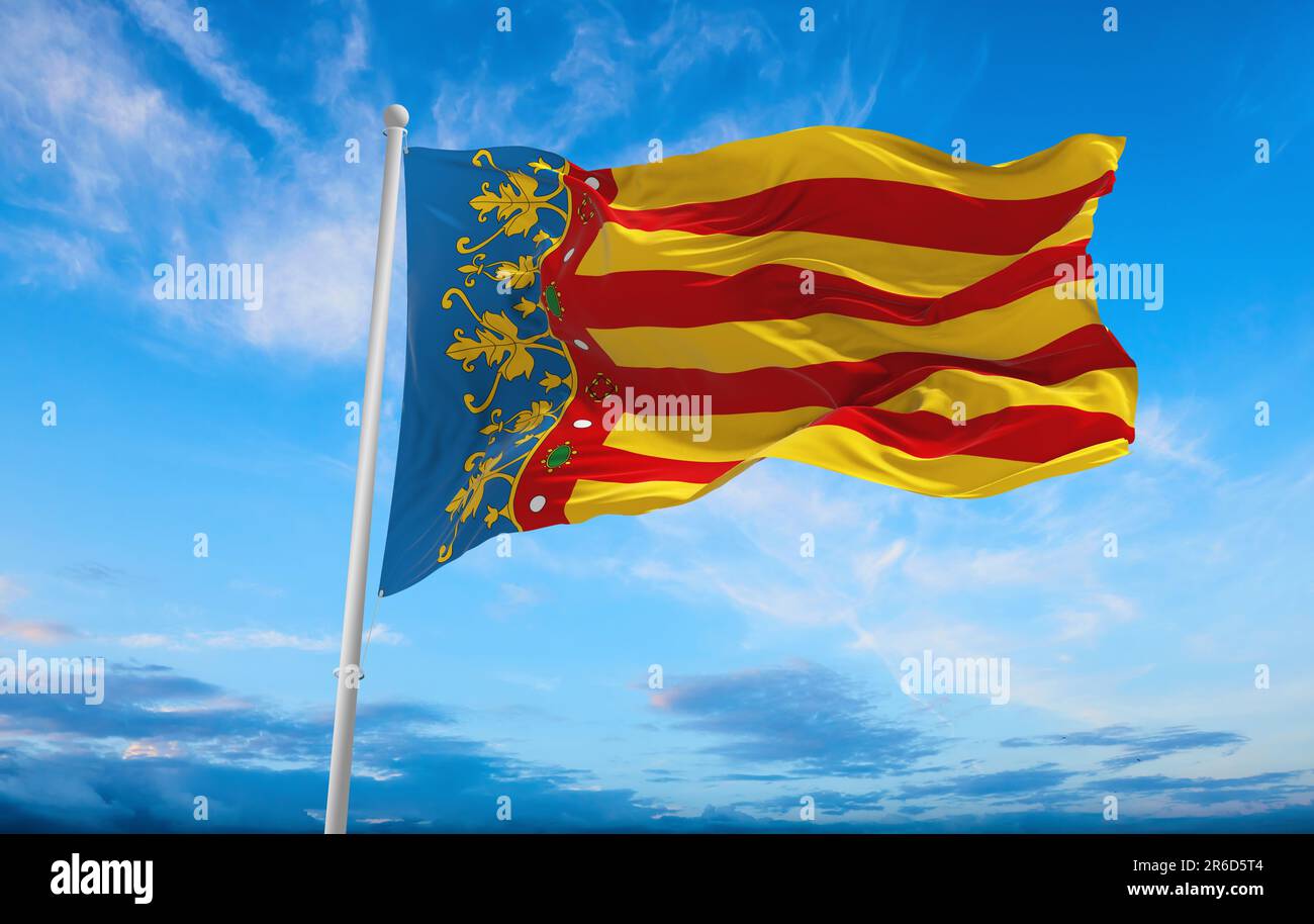 flag of Ibero-Romance peoples Valencians at cloudy sky background ...