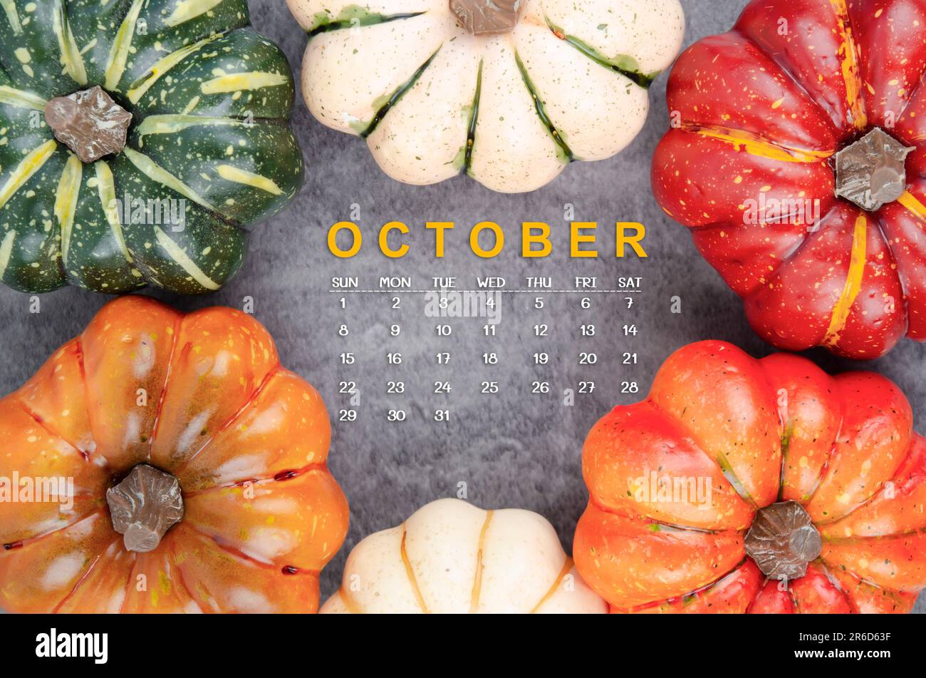 October 2023 Calendar and pumpkins with autuma leaf on old wood ...