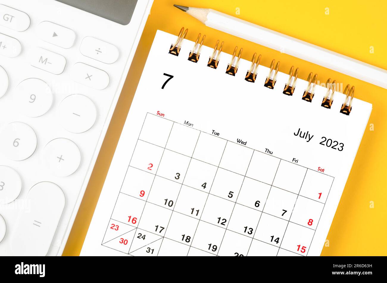 July 2023 Monthly desk calendar for 2023 year and calculator with pen ...