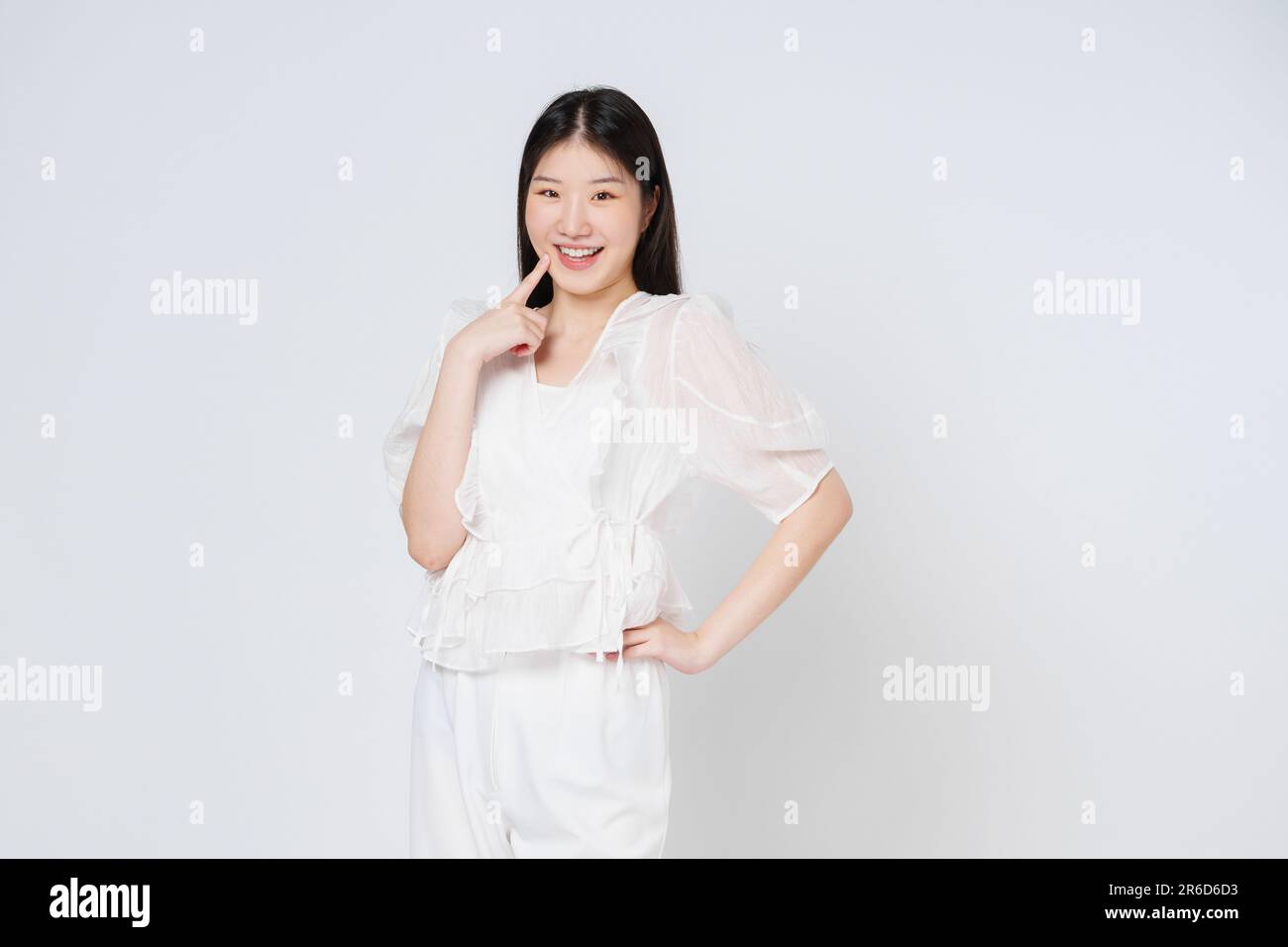 Young woman has nice smile and get satisfied something, look at camera ...