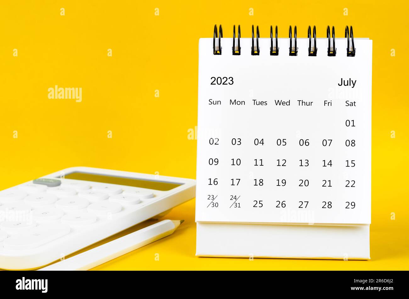 July 2023 Monthly desk calendar for 2023 year and calculator with pen ...