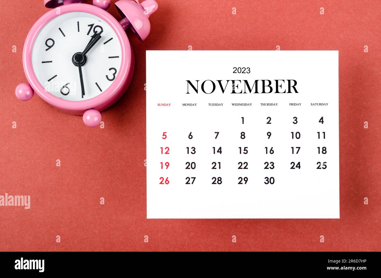 November 2023 Monthly calendar year with alarm clock on red and black ...