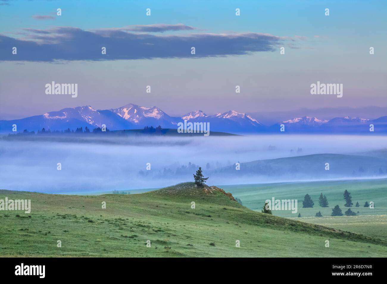 morning light on peaks of the flint creek range and foggy foothills ...