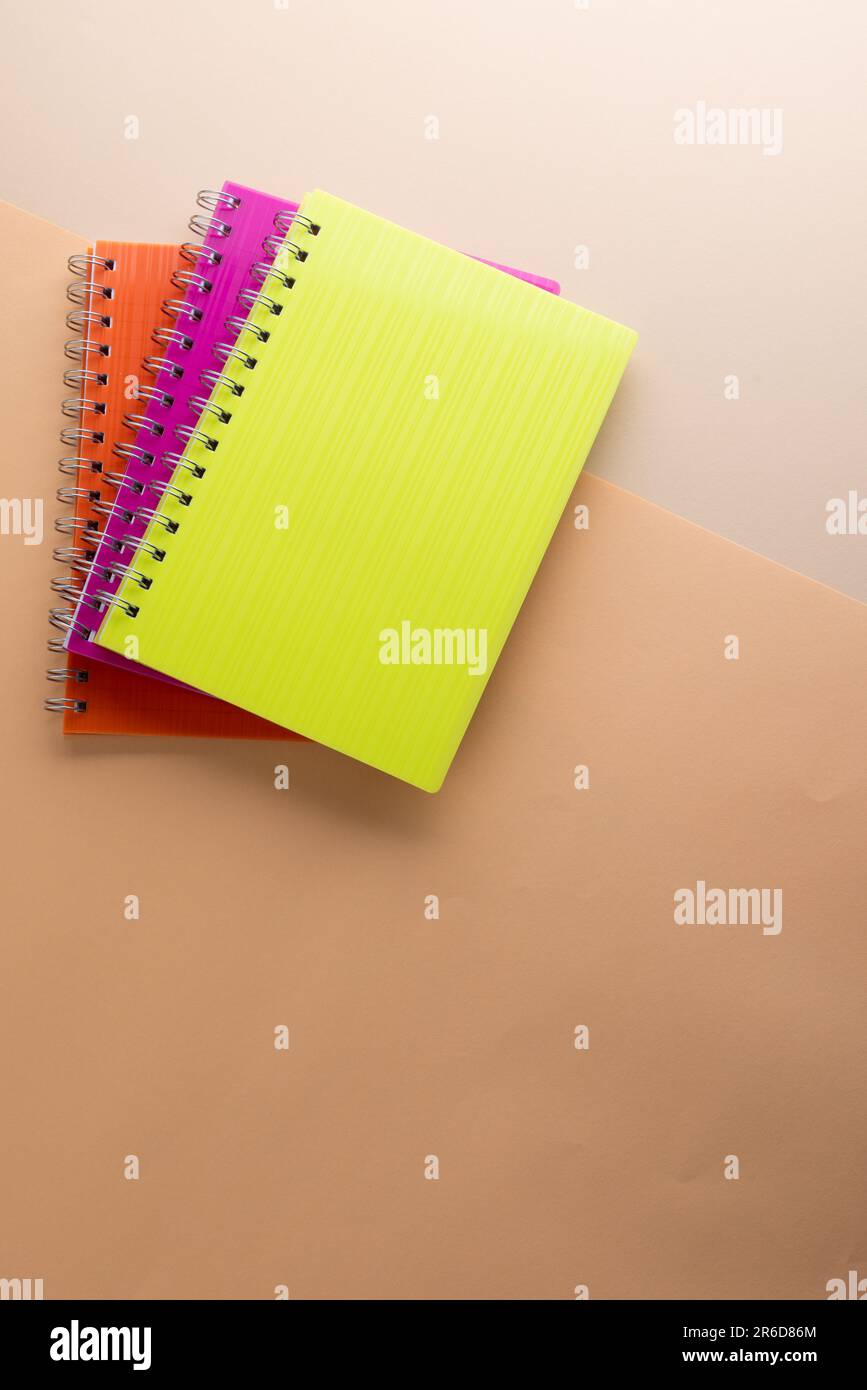 Flat lay of three notebooks with binding with copy space on orange ...