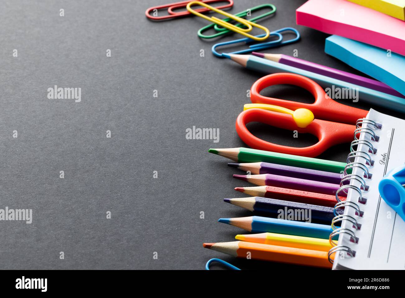 Close up of coloured pencils and school materials with copy space on ...