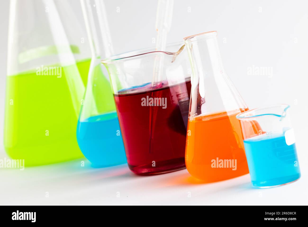 Close up of chemistry beakers and dishes with liquid and copy space on ...