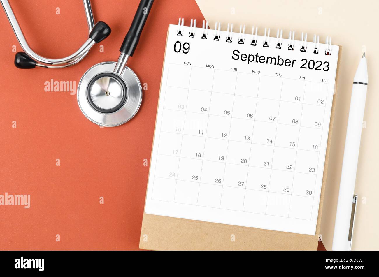 stethoscope medical and September 2023 desk calendar with pen on the ...