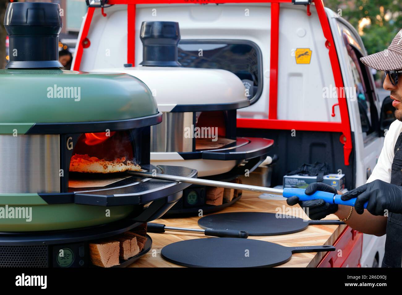 A pizza being baked in a Gozney Dome portable pizza oven at a CG Pizza ...