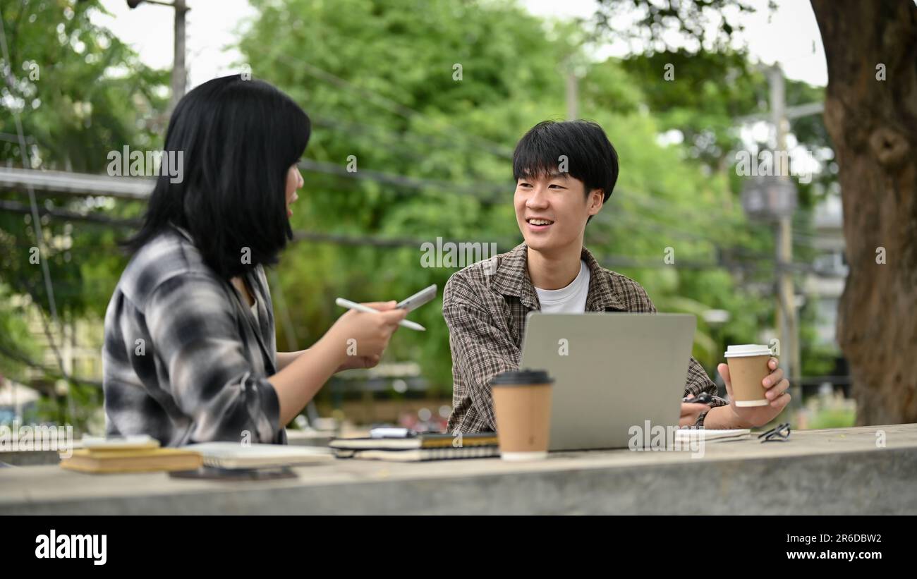 A serious young Asian female college student is talking and sharing her ...