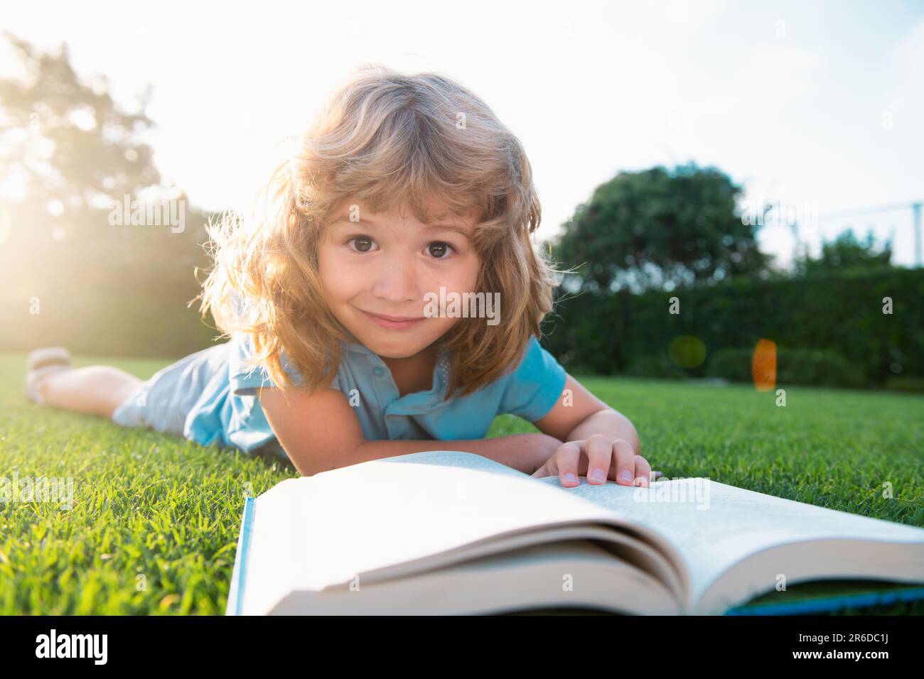 Kid read book. Child school and outdoor education. Nature and park ...