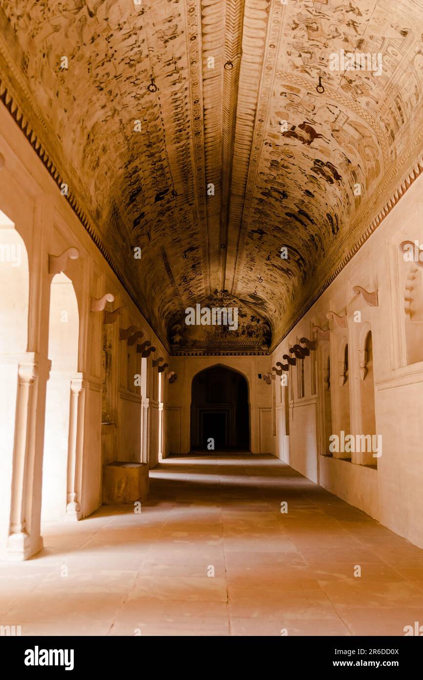 The interior of the long hallway with an archway entrance in Orchha ...