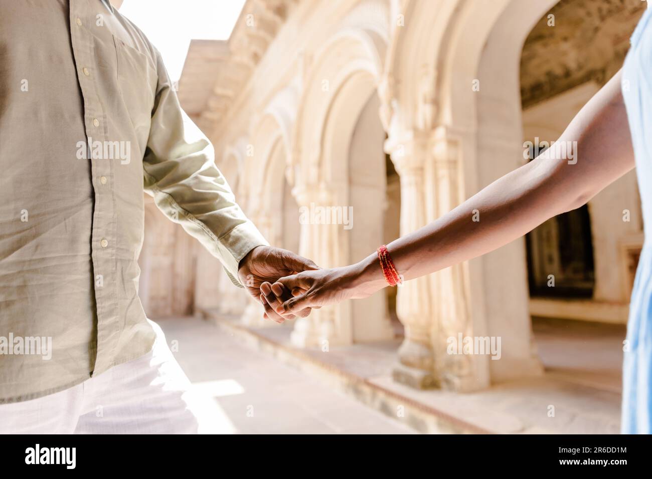 A loving couple walking hand in front of the columns and majestic ...