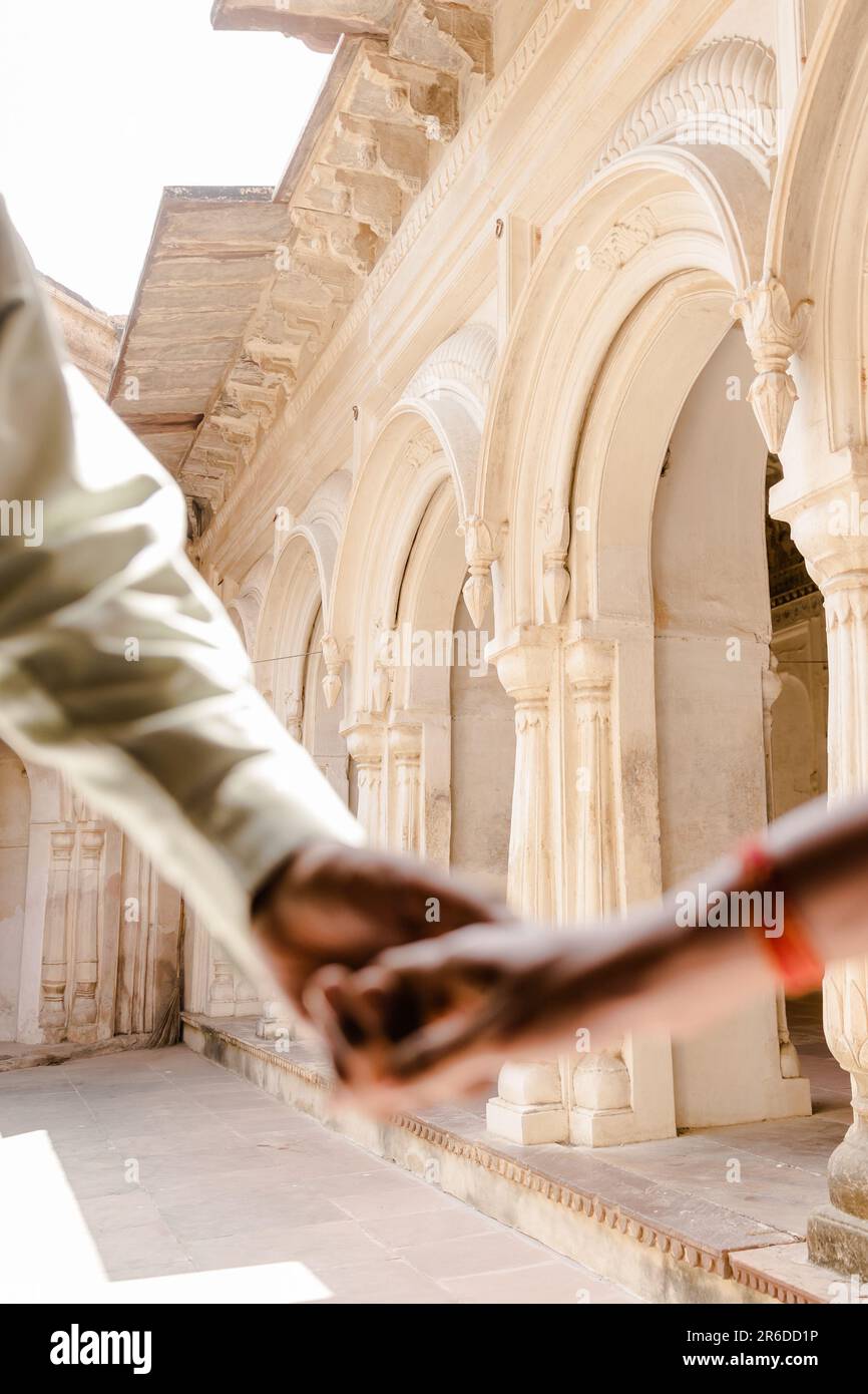 A loving couple walking hand in front of the columns and majestic ...