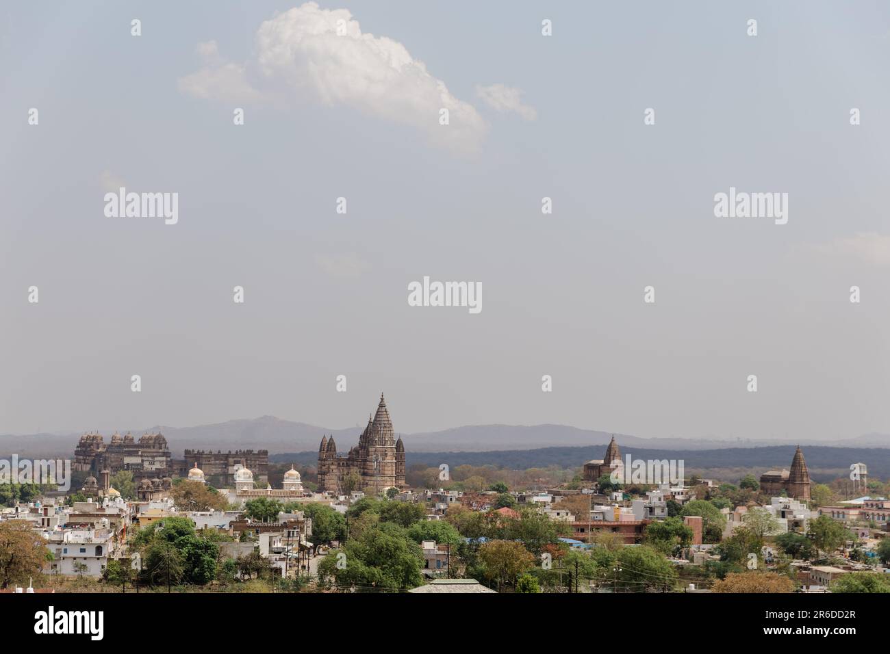 An aerial view of Orchha Fort in India in the distance, sunlit with a ...