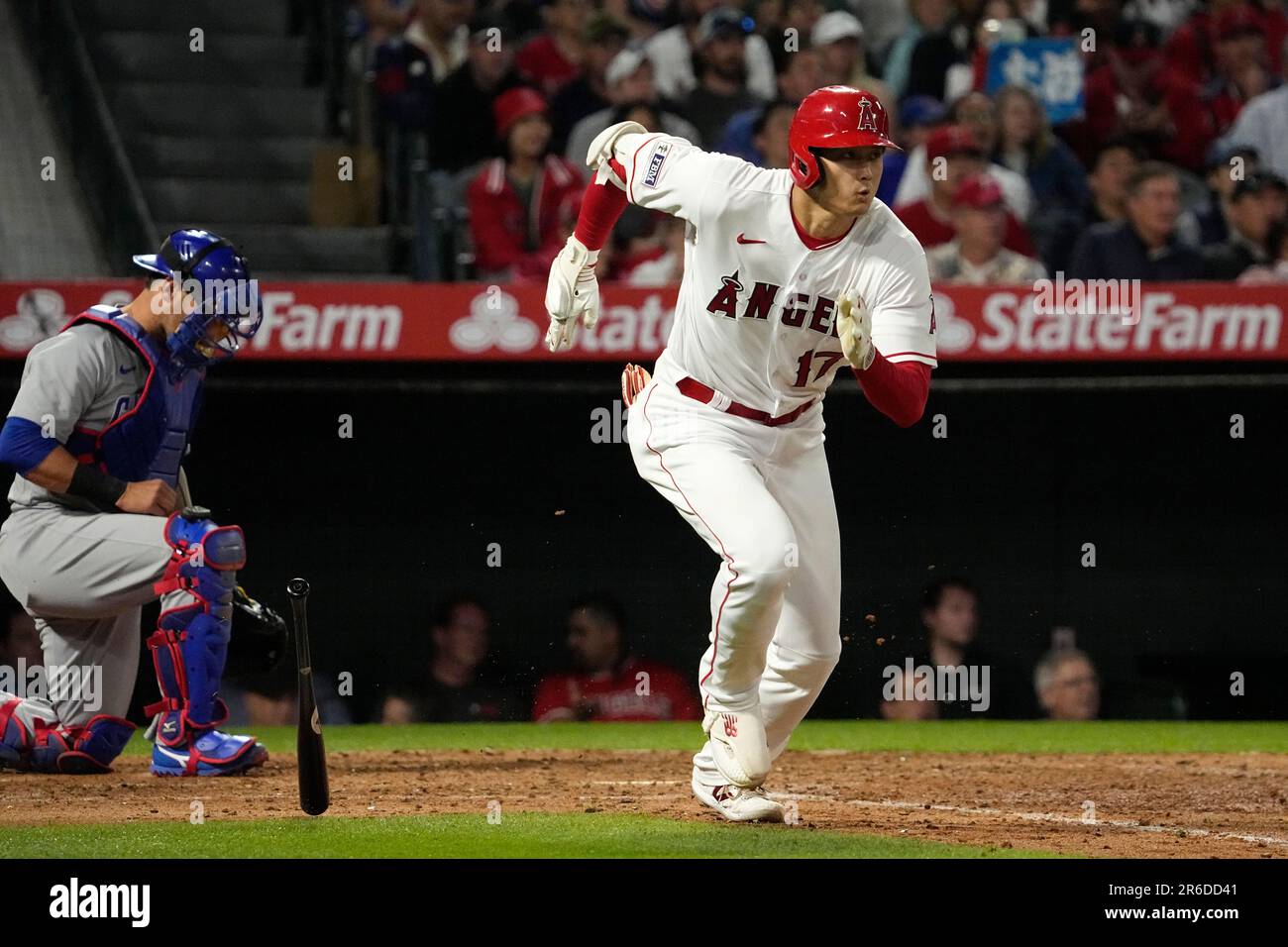 Los Angeles Angels' Shohei Ohtani, right, heads to first for a single ...