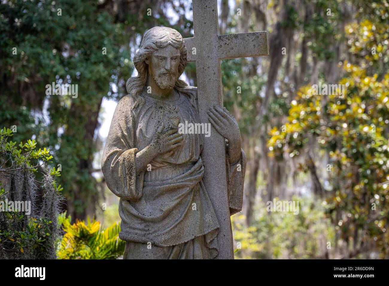 Statue of Jesus holding a cross at historic Bonaventure Cemetery in ...