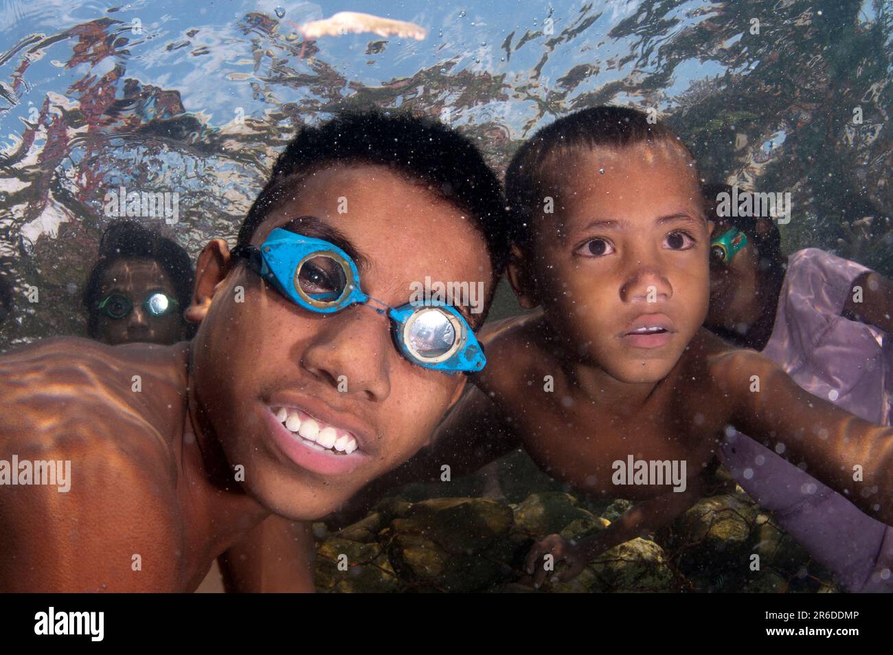 Kids with goggles underwater, Pier, Reta Island, Alor, Indonesia Stock ...