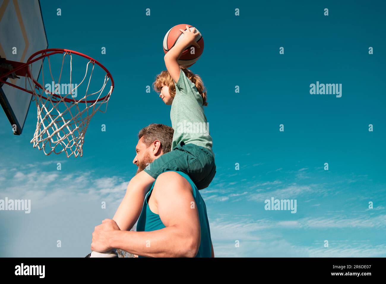 Father and son playing basketball. Sports Concept. Boy child sitting on ...