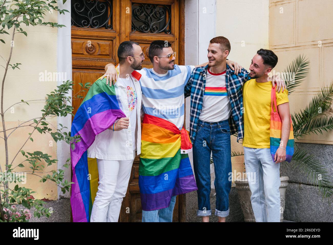 oyful Group of Four Gay Friends Embracing, Walking Out of their Home ...