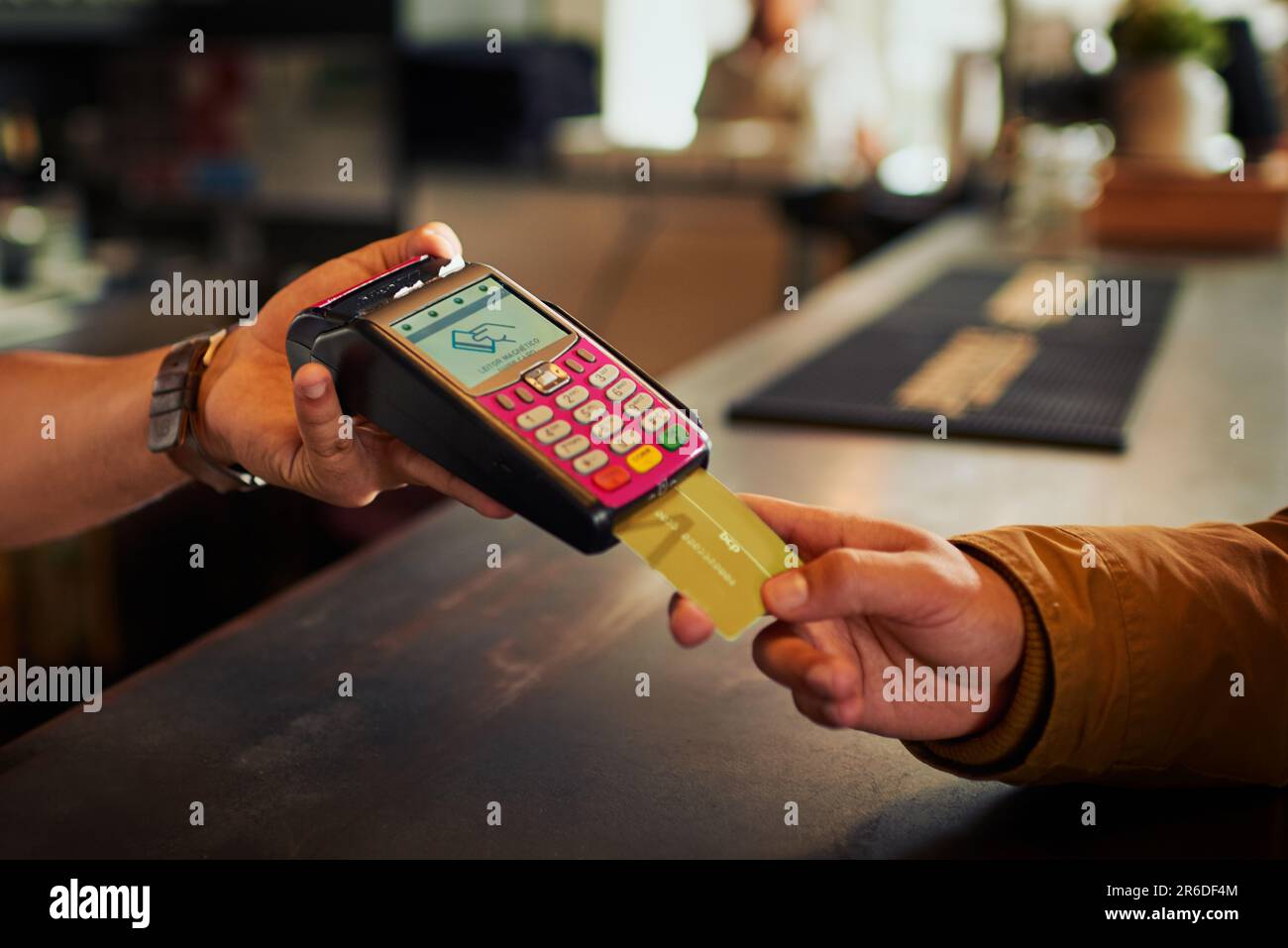 Debit card, point of sale and hands of coffee shop people, cashier or ...