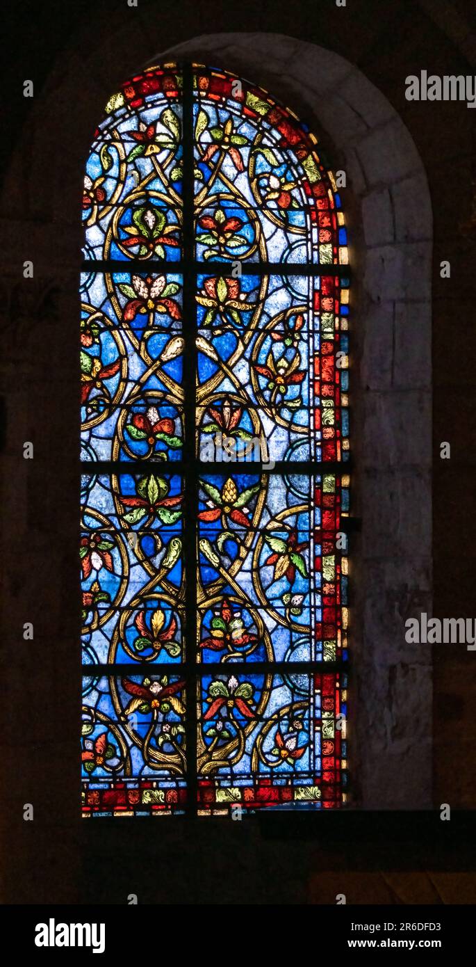 16 May 2023. Stained glass window set into stone arch St. Denis ...