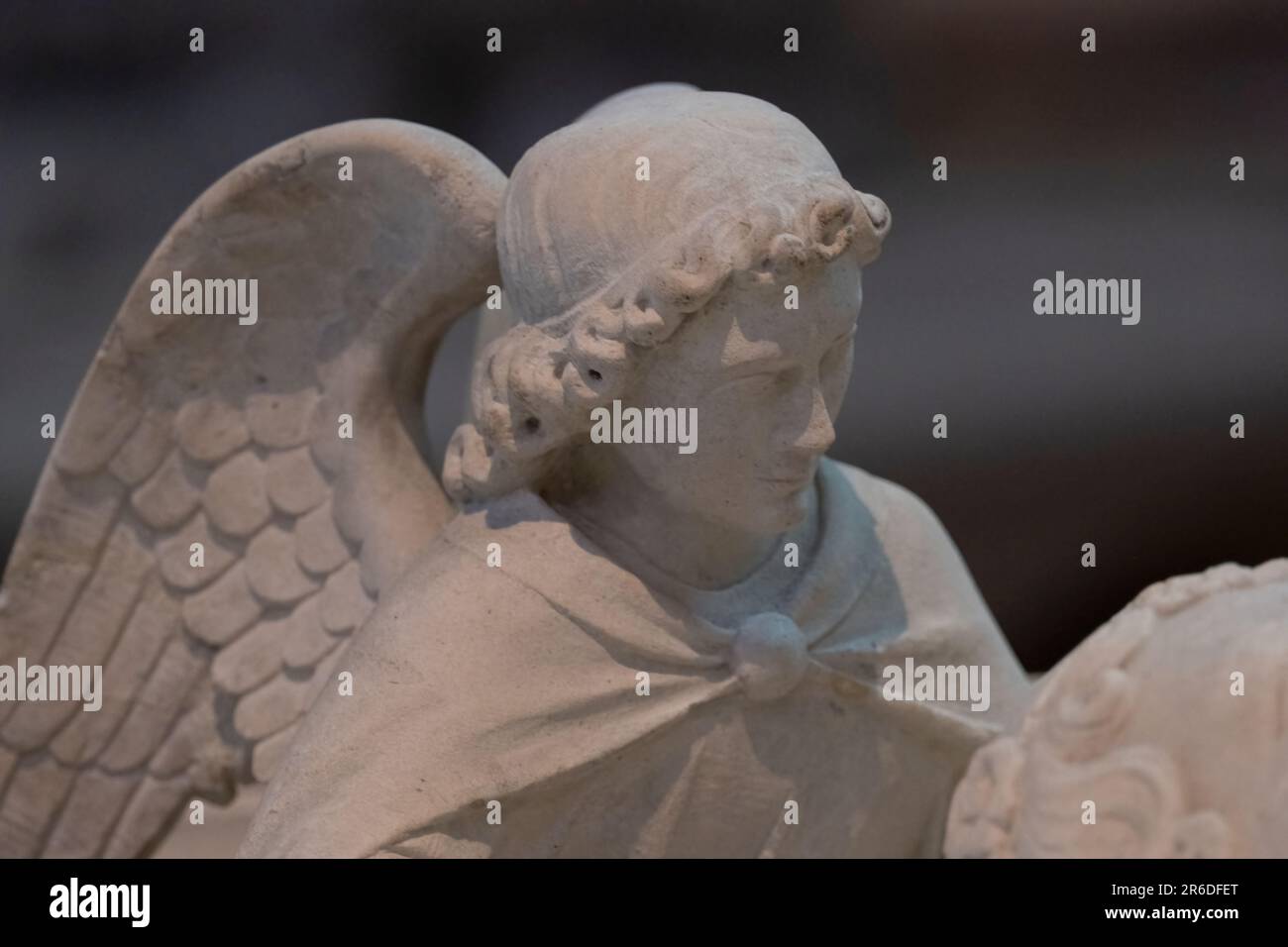 Close up detail of angel in a cathedral carved in marble showing tip of ...