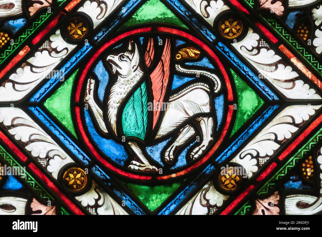 Stained glass detail of an early medieval mythical creature, a winged ...