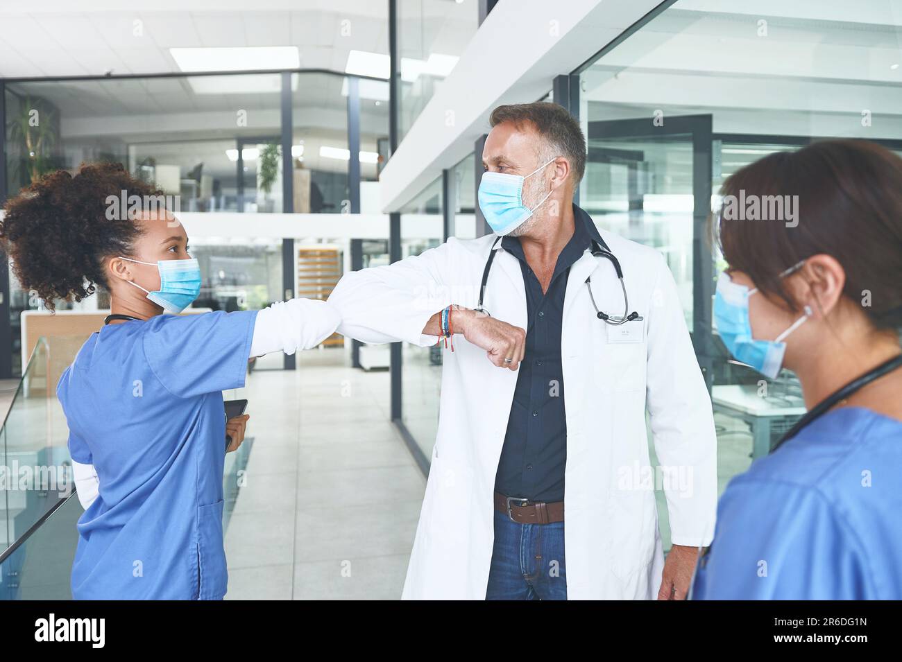 The new normal handshake. a handsome mature doctor standing and elbow ...