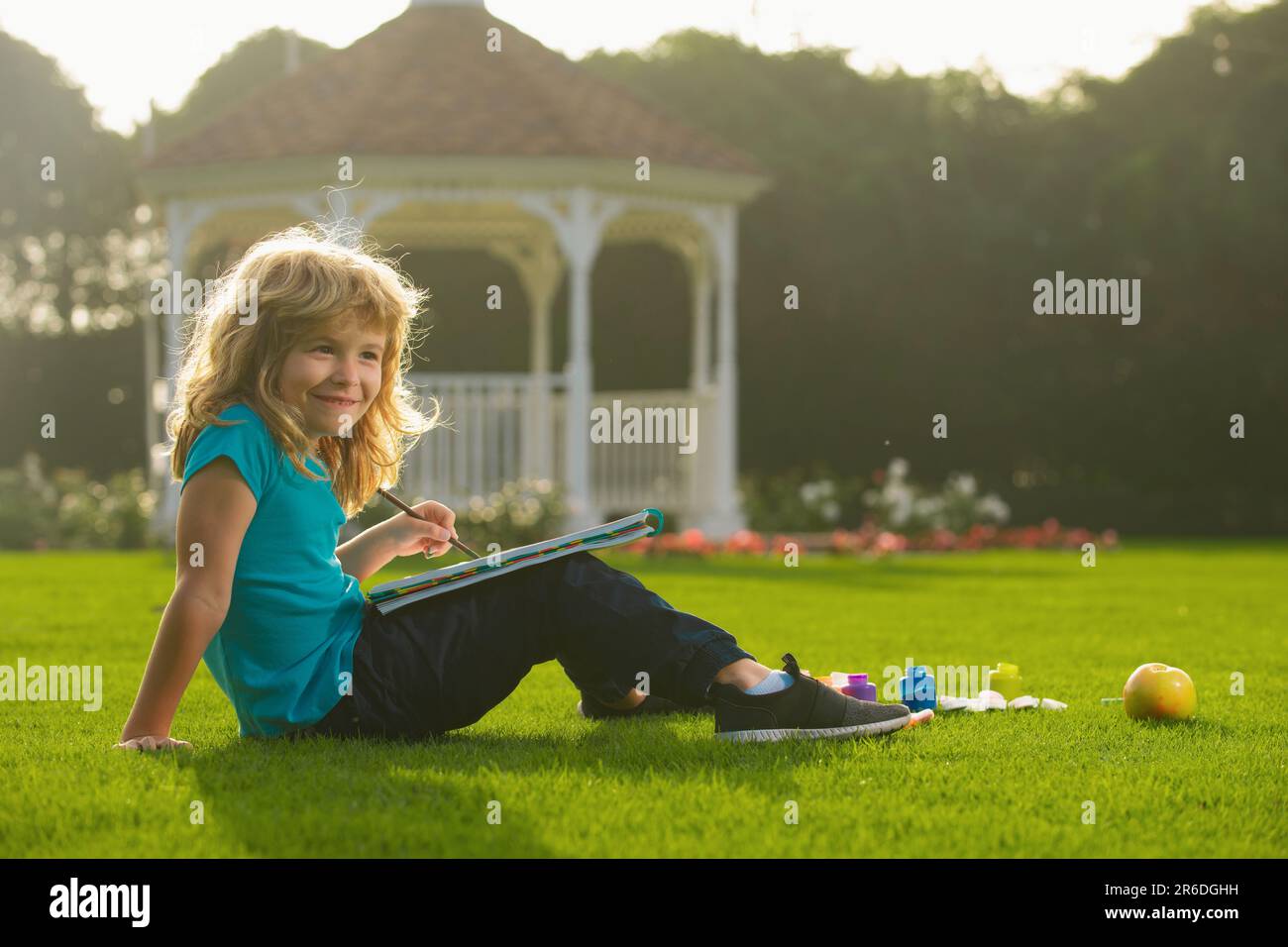 Children draw paint pictures outside, childrens creativity. Child boy ...