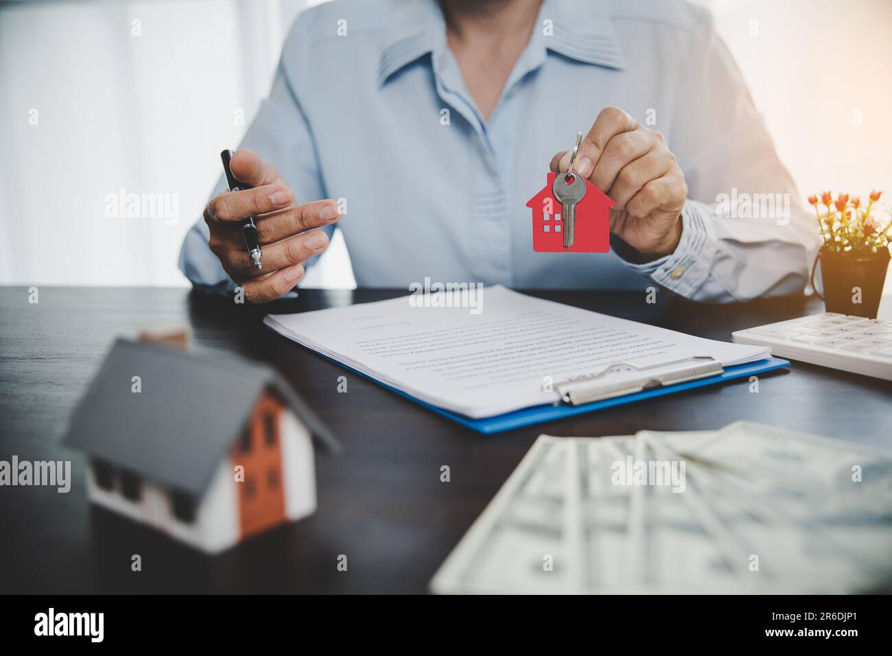 Real estate agent offer hand holding house model with key for customer ...