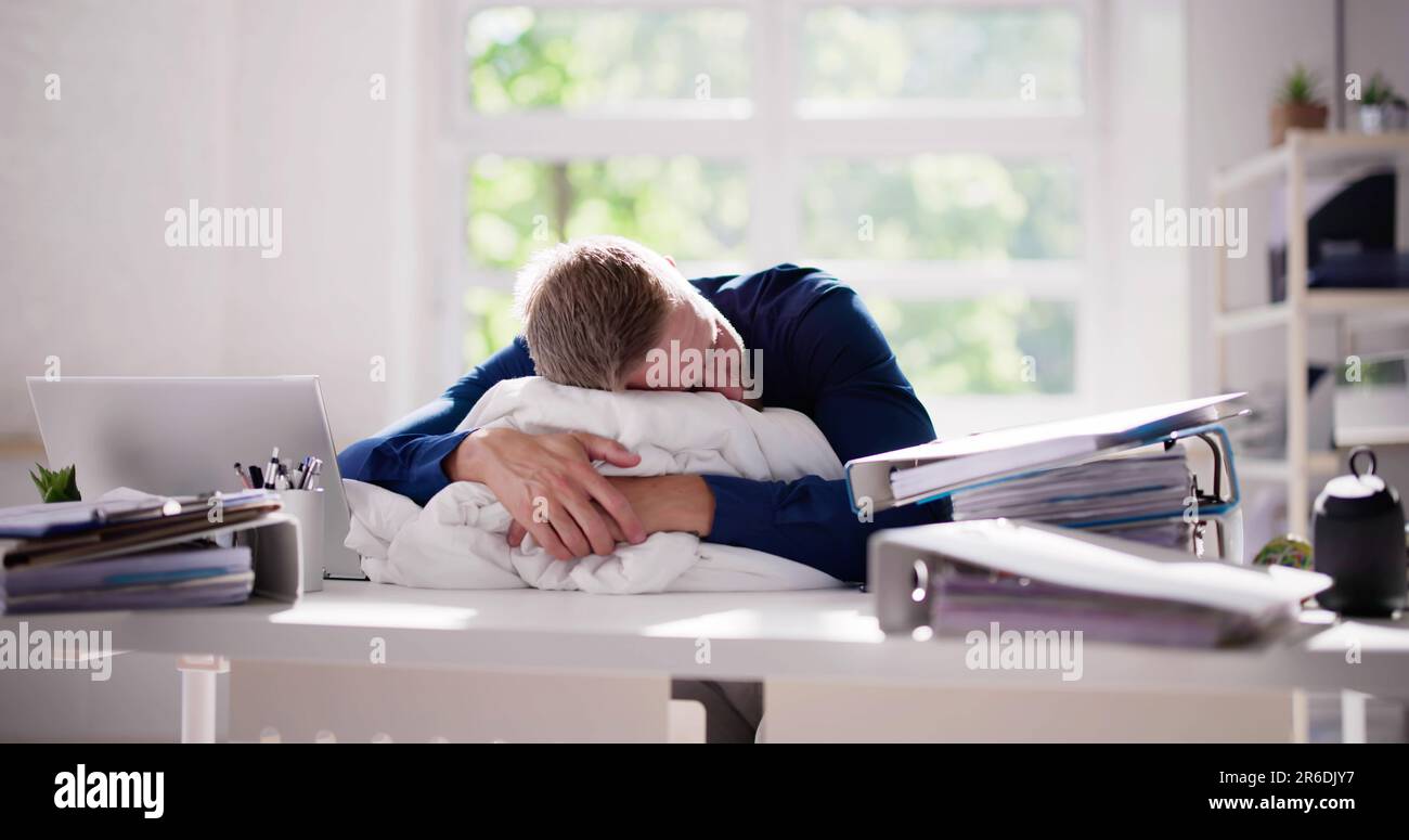 Office workers sleeping at desk hi-res stock photography and images - Alamy